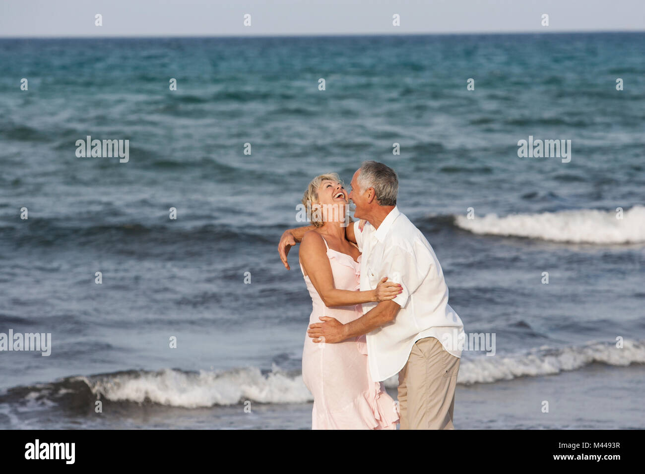Couple hugging on beach, Palma de Mallorca, Spain Stock Photo - Alamy