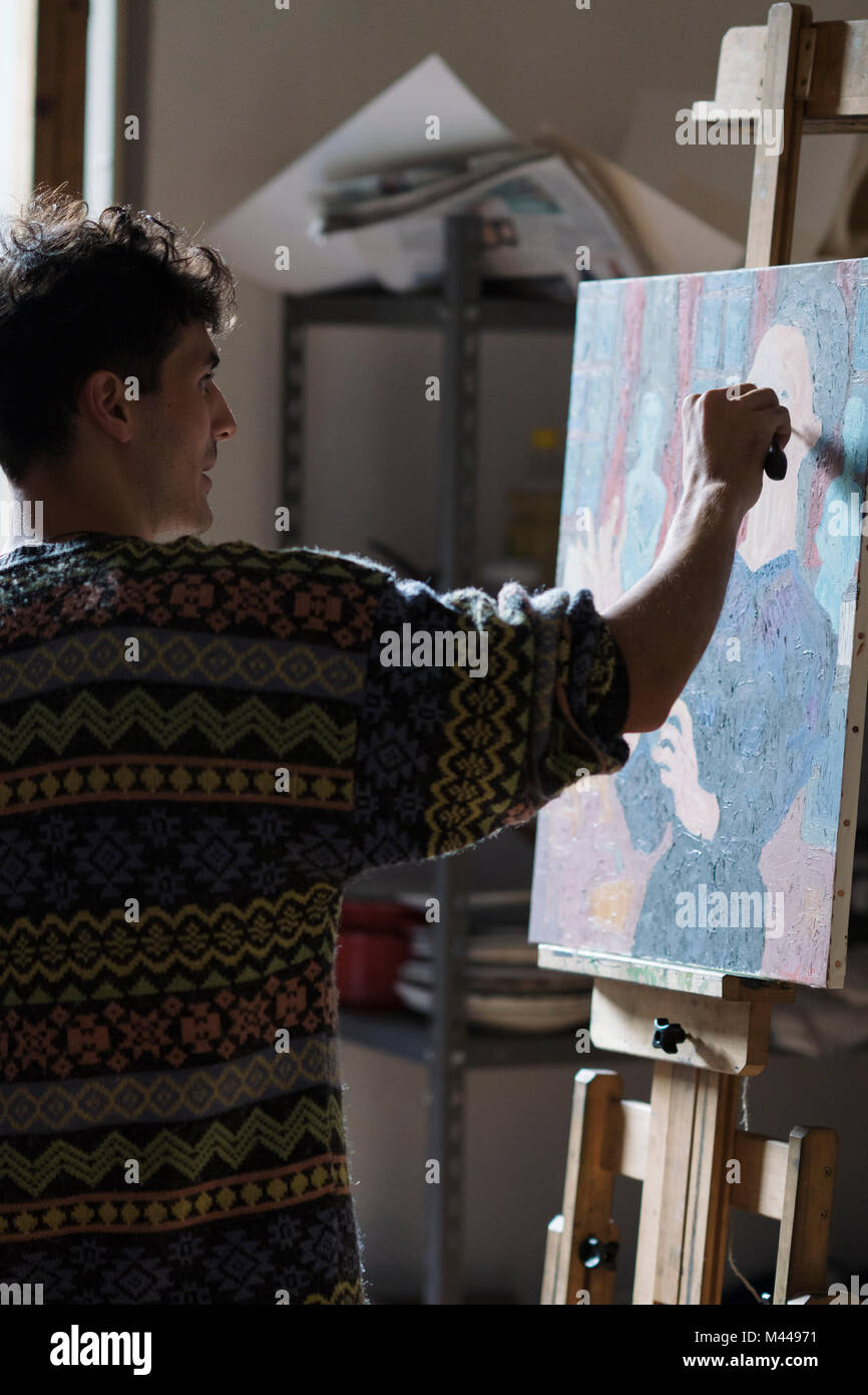 Male artist painting canvas in artists studio Stock Photo - Alamy