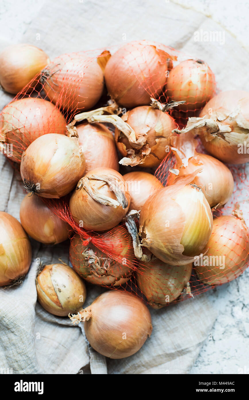 Onions in net bag Stock Photo - Alamy