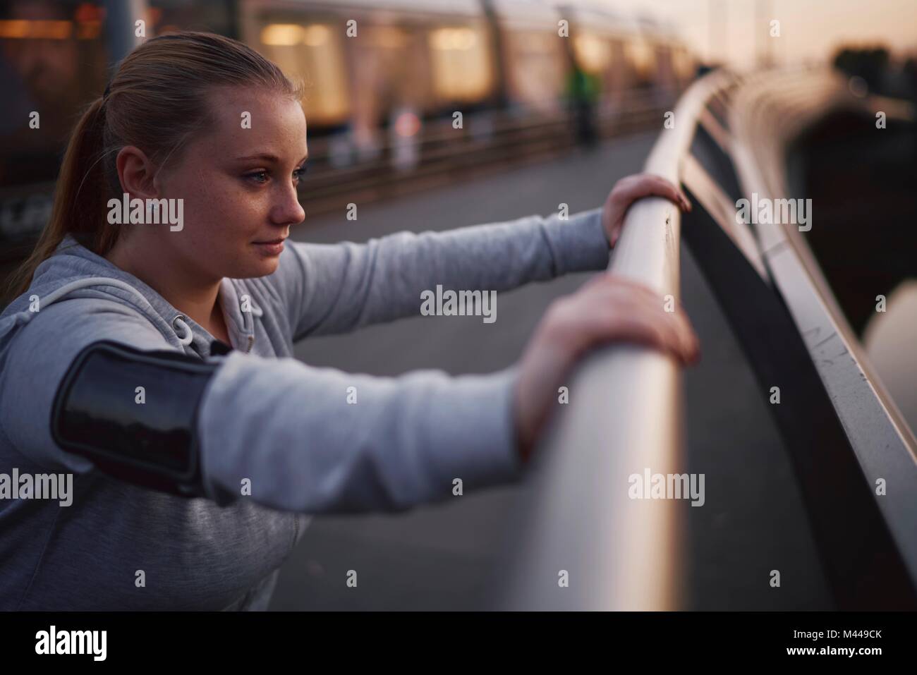Woman leaning against rail hi-res stock photography and images - Alamy