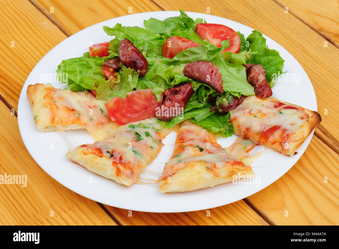 Pizza slices and salad Stock Photo - Alamy