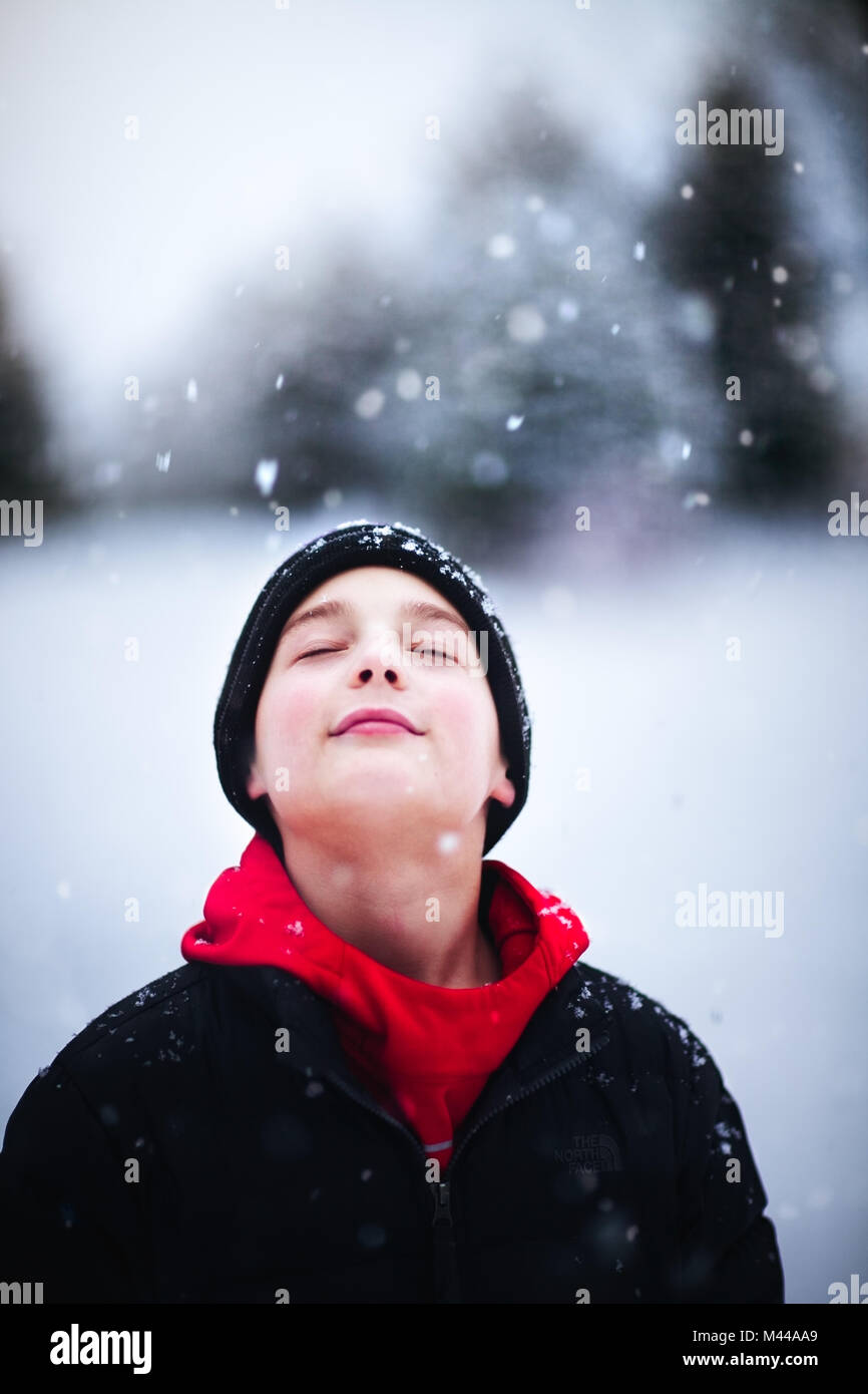 Portrait of boy in falling snow Stock Photo - Alamy
