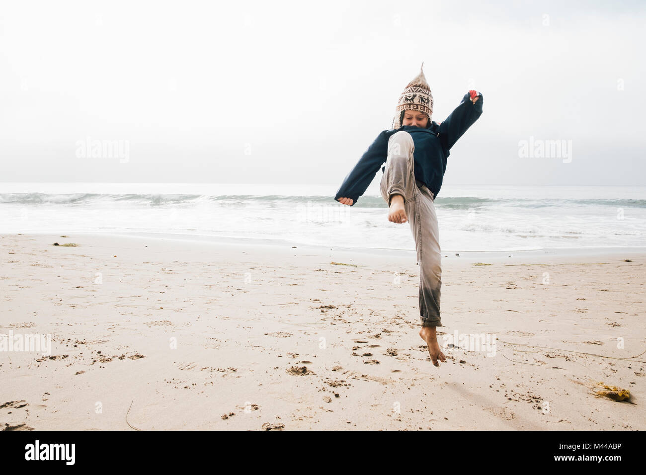 Young boy on beach, jumping, mid air Stock Photo - Alamy