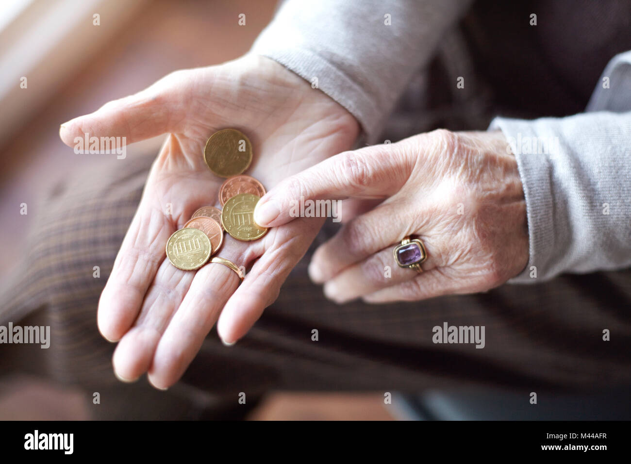 Old woman counting coins hi-res stock photography and images - Alamy