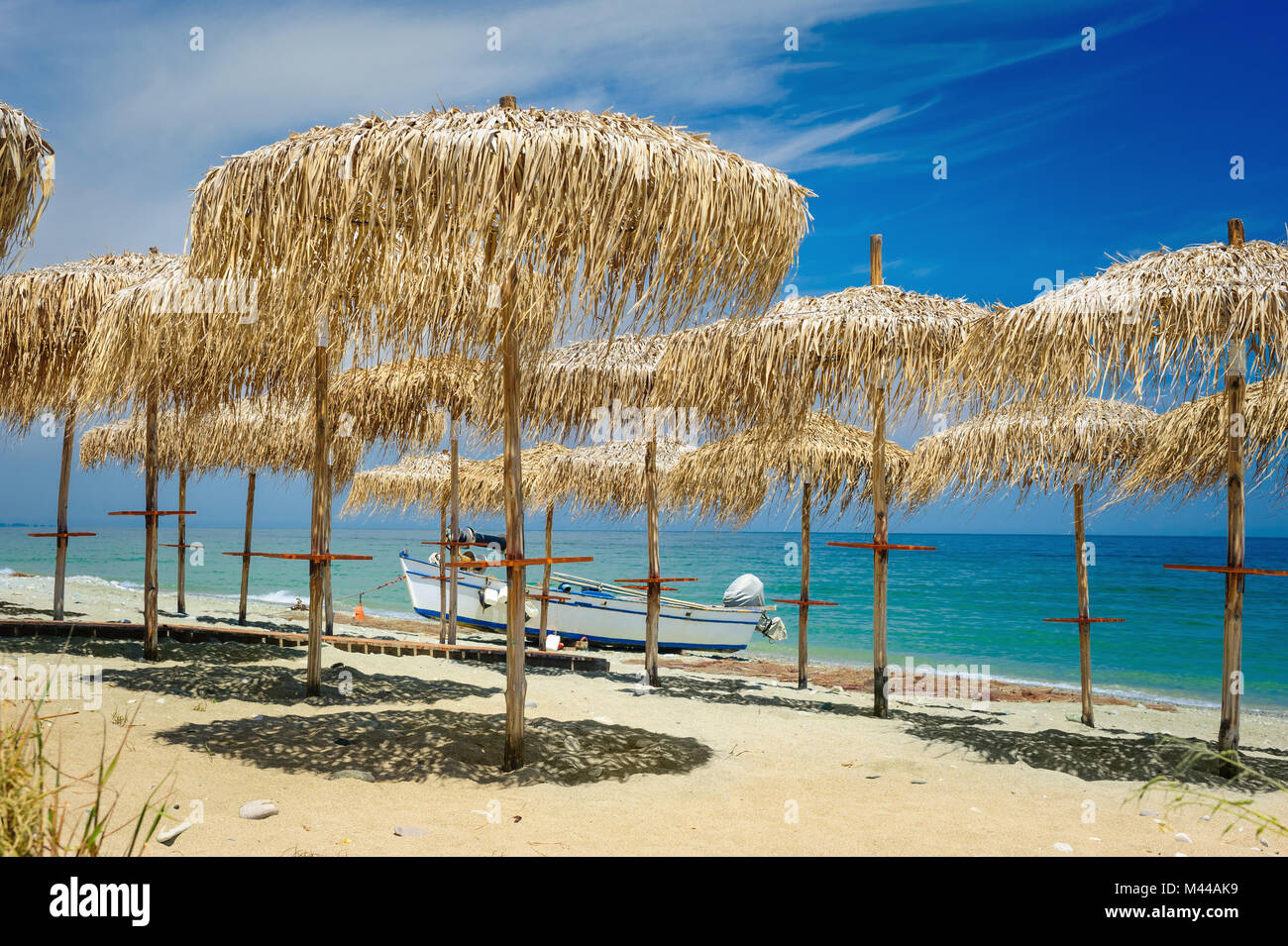 Reed umbrellas on the beach Stock Photo - Alamy