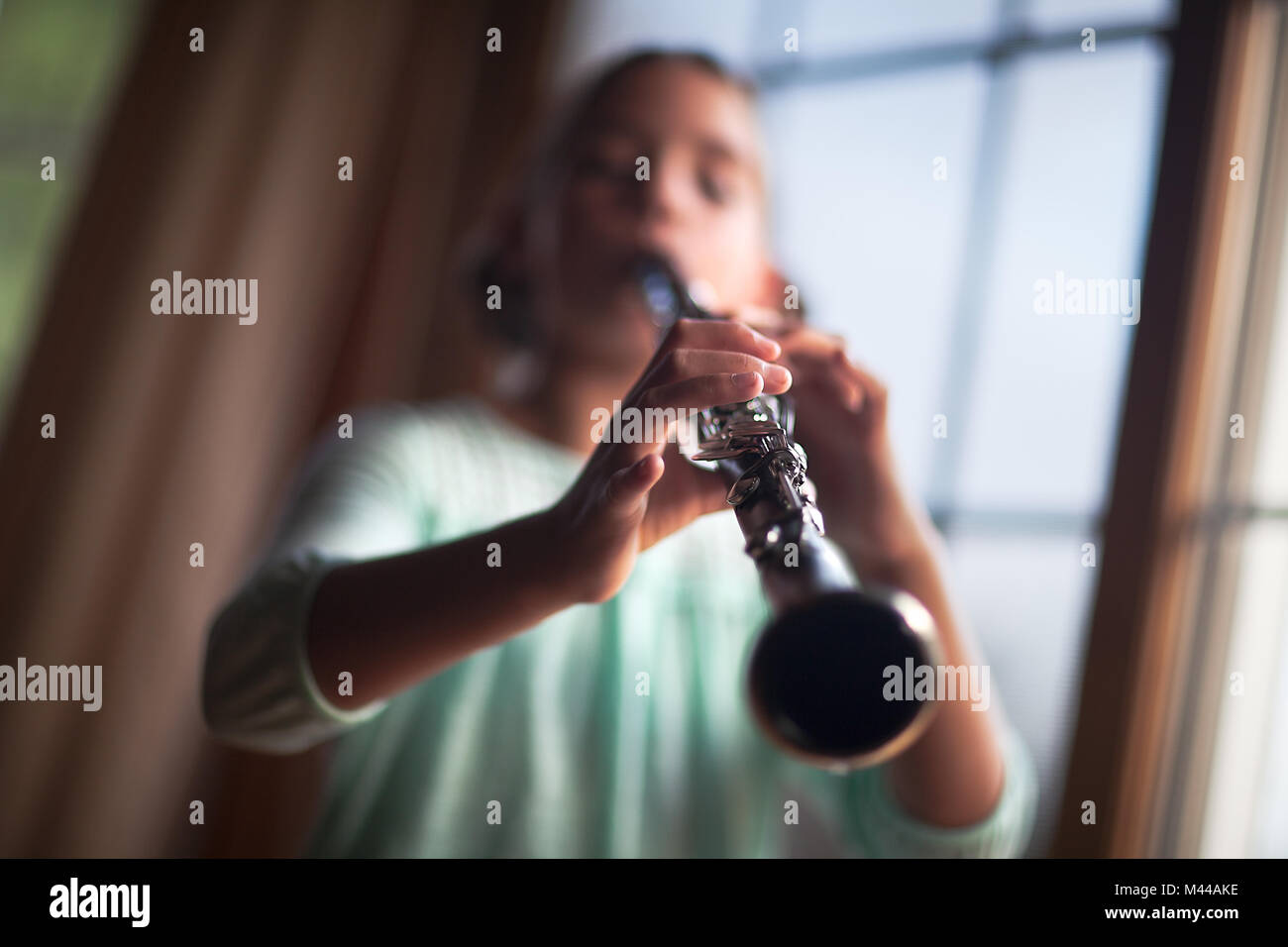 Young clarinettist playing her clarinet Stock Photo - Alamy
