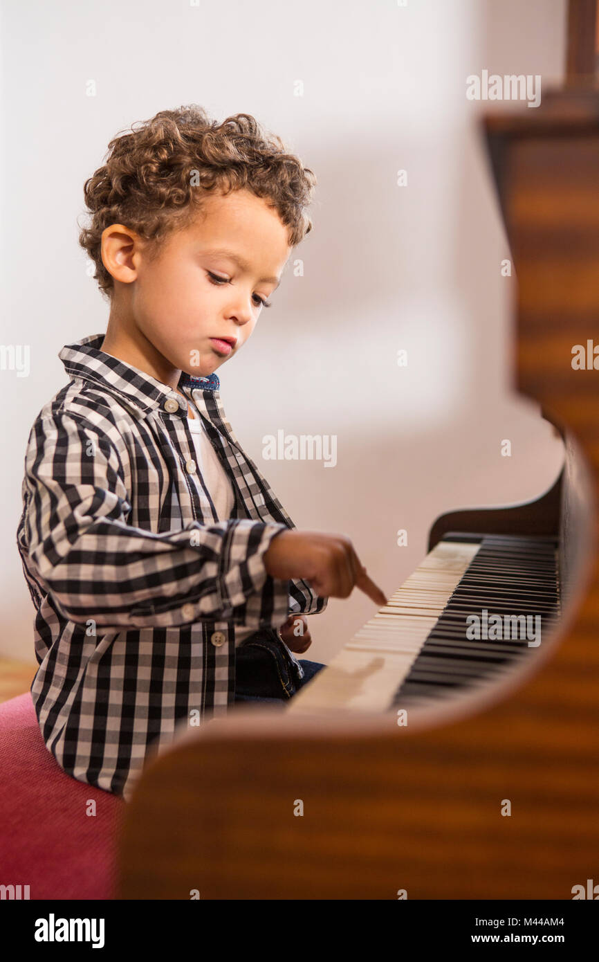 Boy playing piano Stock Photo - Alamy
