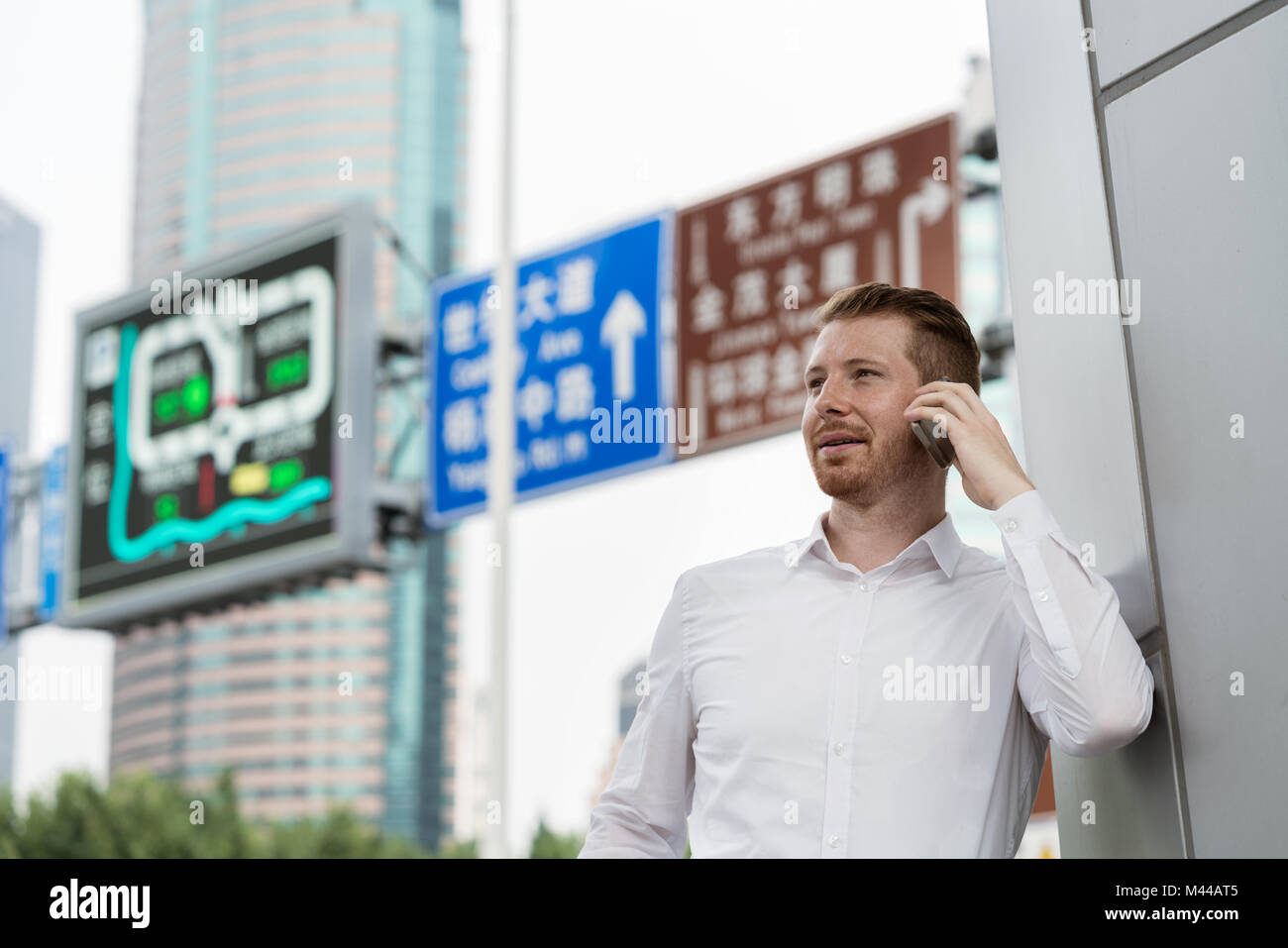 Young businessman making smartphone call in city, Shanghai, China Stock ...