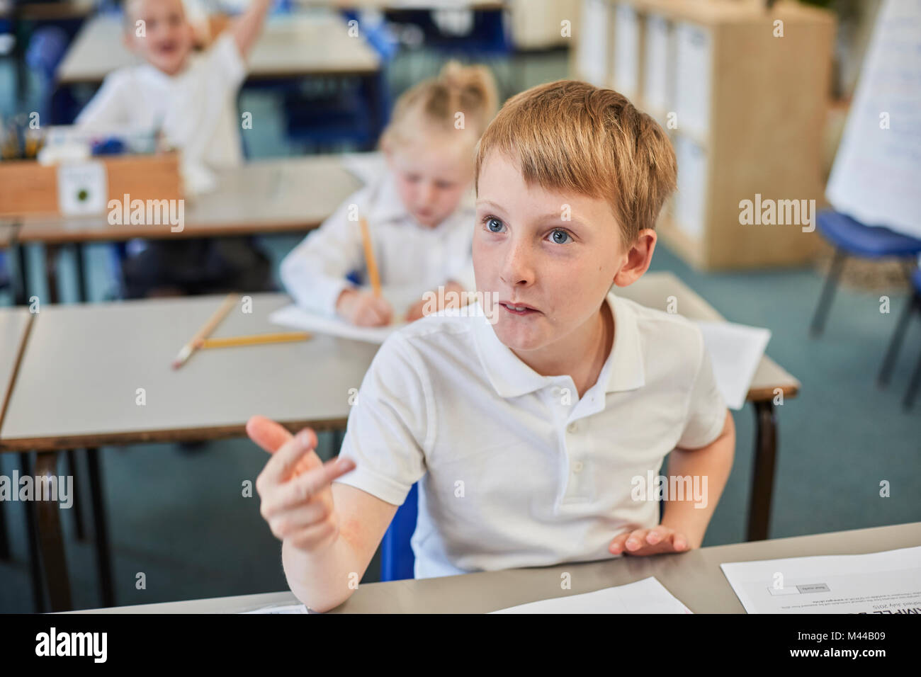 Schoolboy counting with fingers in classroom at primary school Stock ...