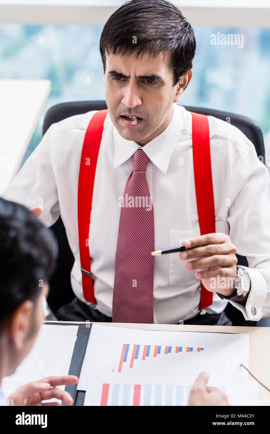 Supervisor talks to subordinate professional in office building Stock ...