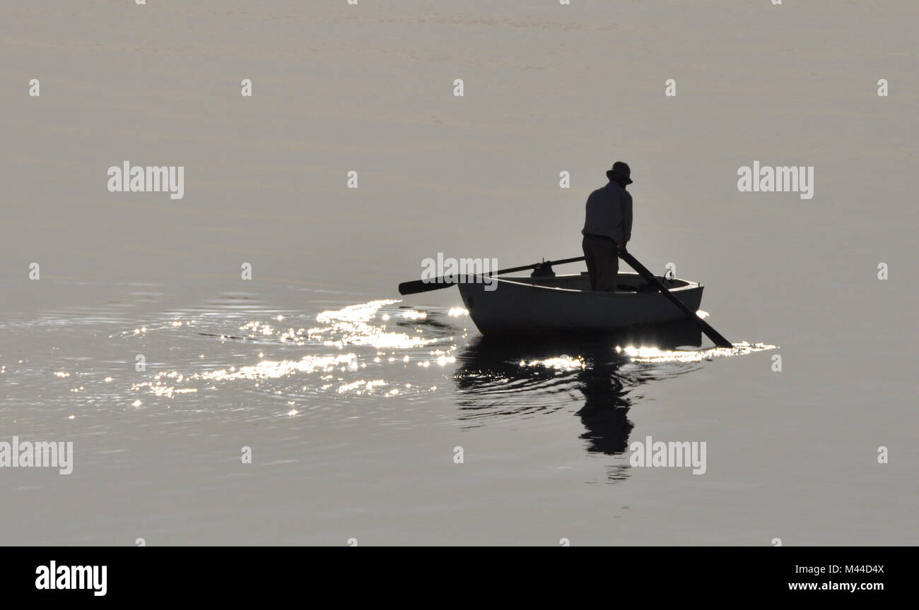 Man rowing his boat checking his Octopus pots in Puerto Pollensa ...