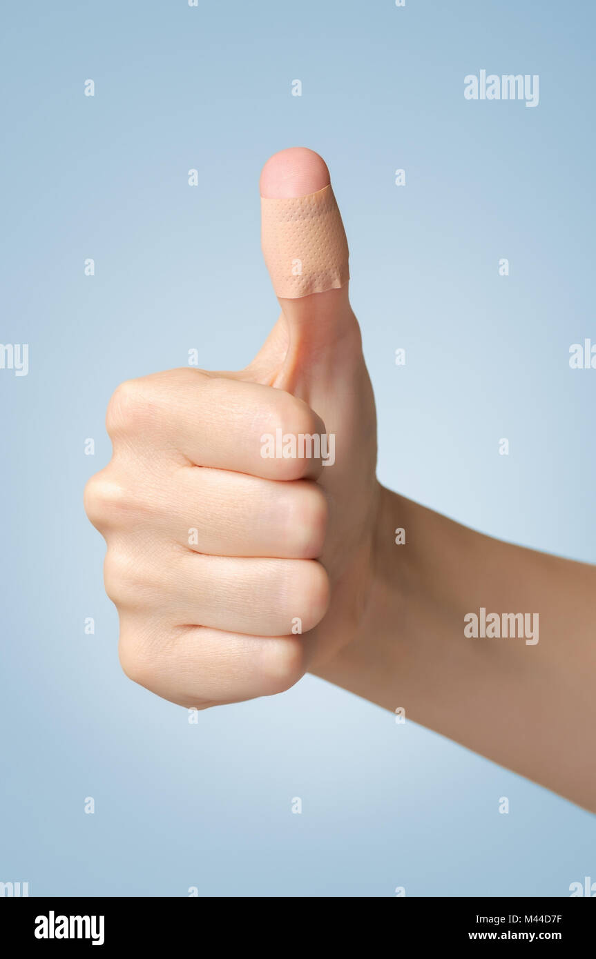 Plaster on female thumb Stock Photo - Alamy