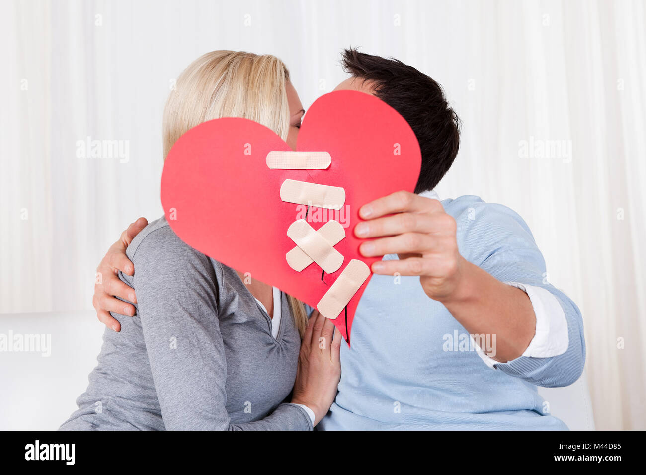 Kissing Couple Holding Paper Red Heart Fixed With Plaster Bandage In ...