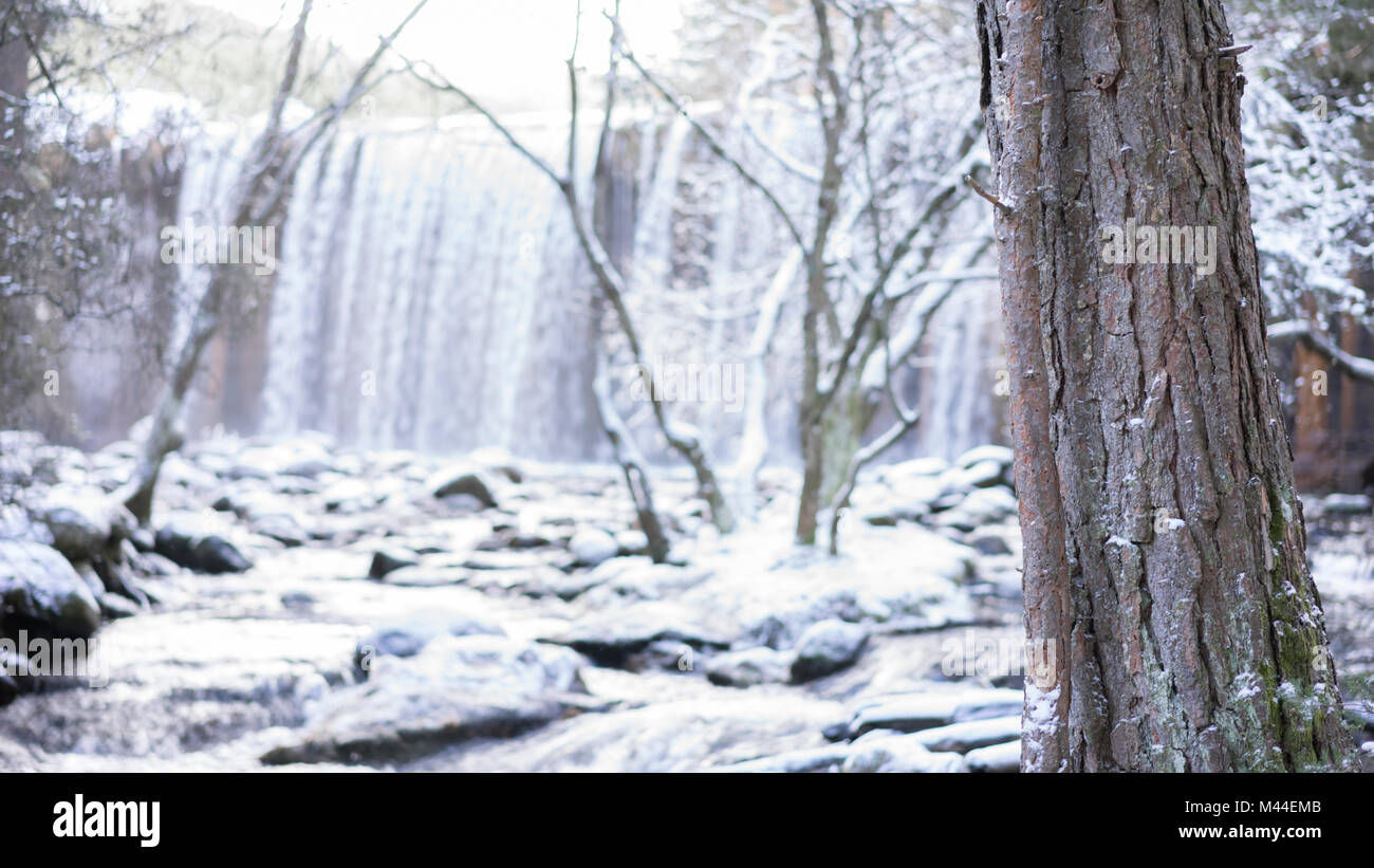Snowy landscape with river and waterfall in the background. frozen ...