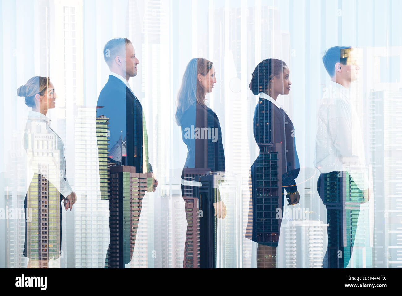 Side view of multiethnic business people standing in row seen through ...