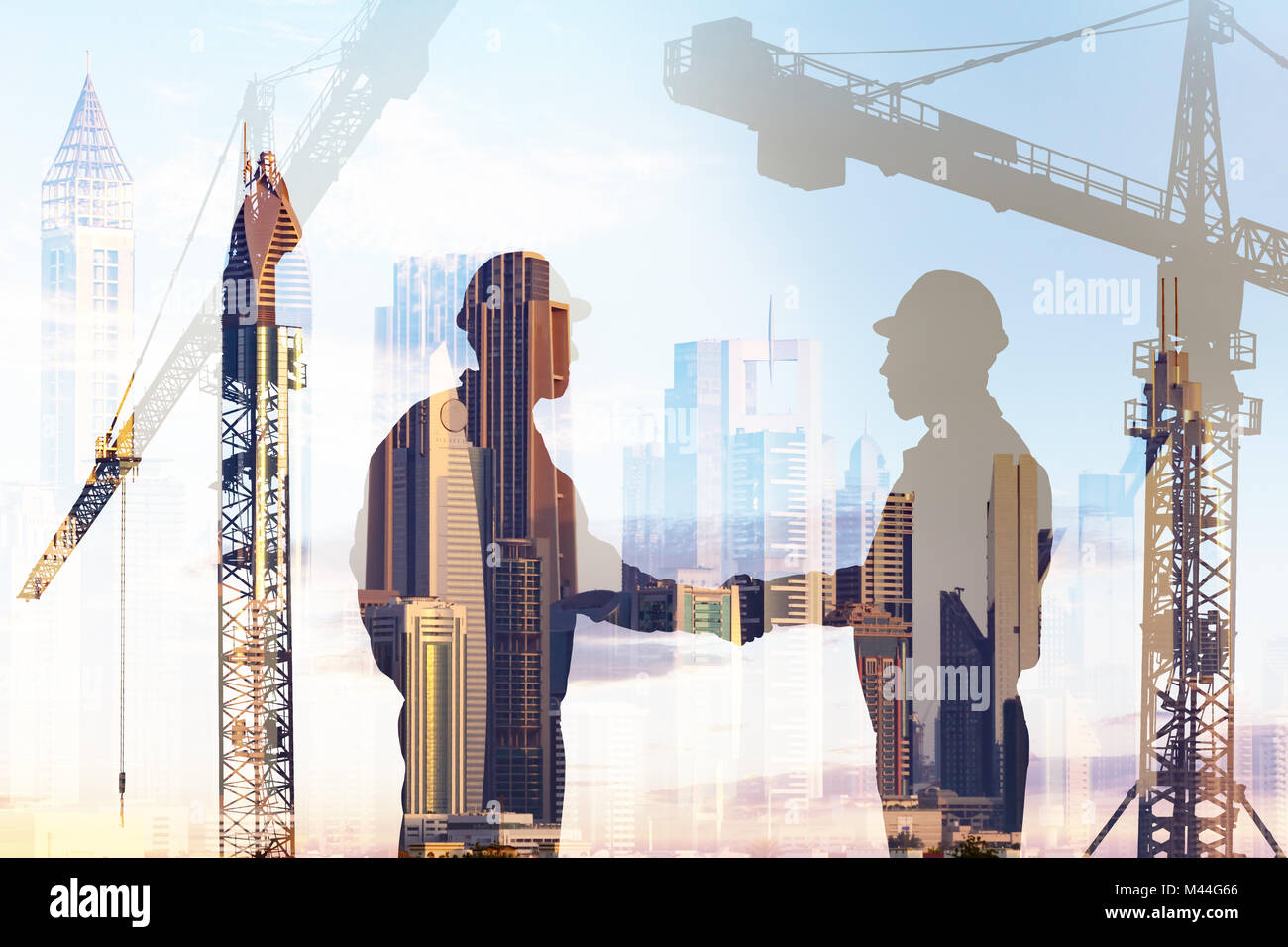 Double exposure of silhouette architects shaking hands over cranes and ...