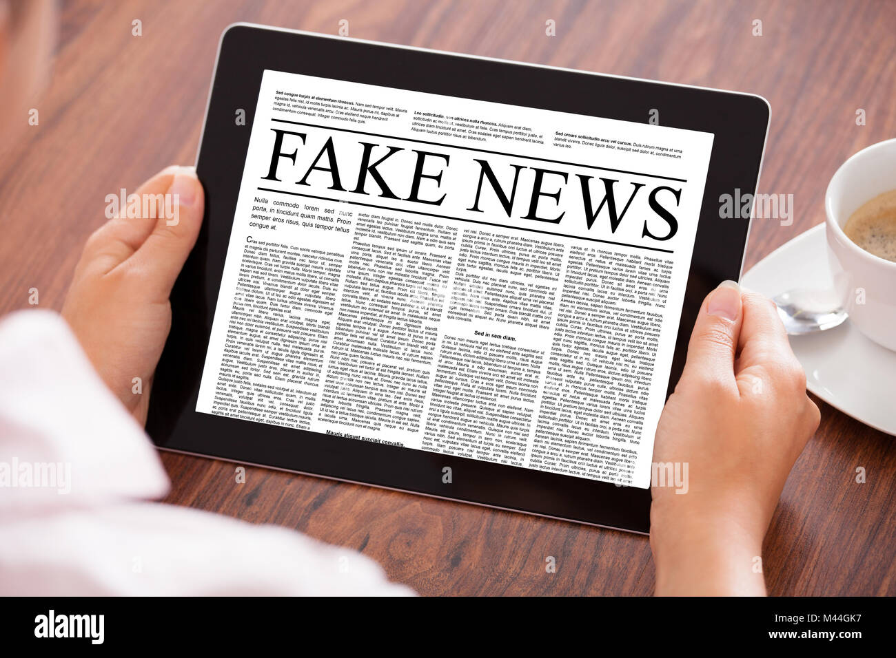 Cropped image of businesswoman reading fake news on digital tablet at ...