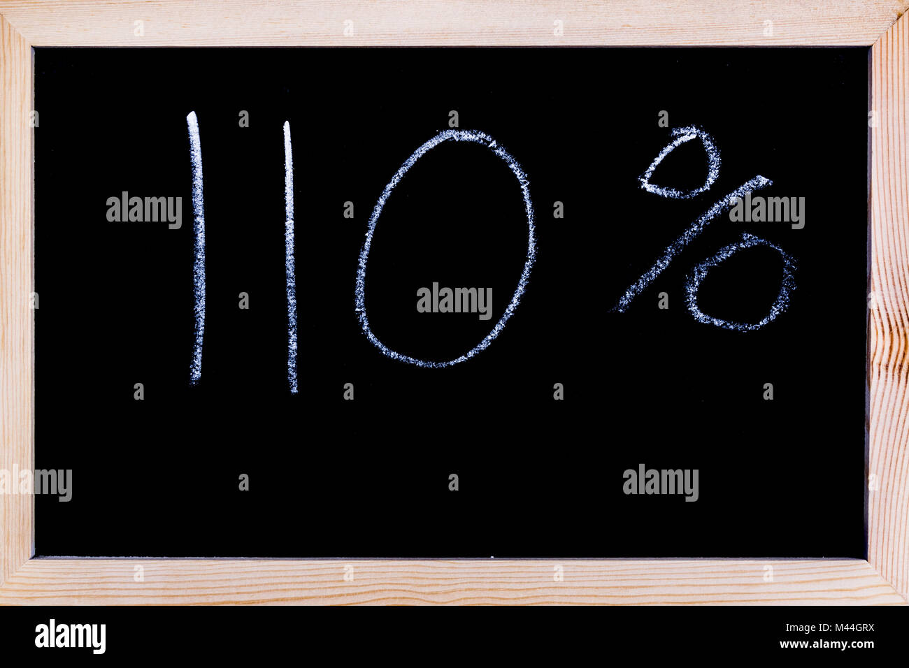 Blackboard with 110% written on it Stock Photo - Alamy