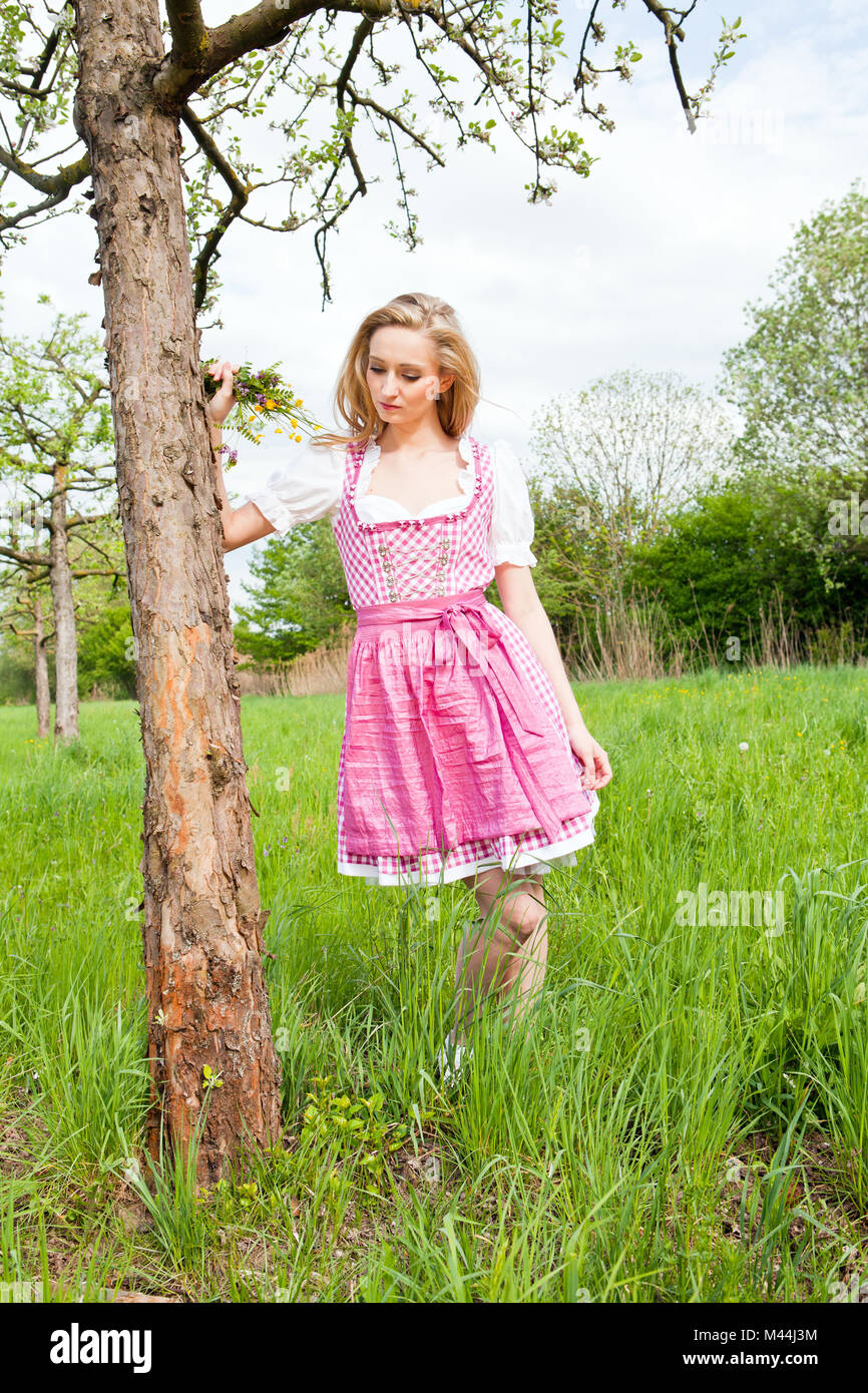 Young beautiful girl with pink dirndl outside Stock Photo - Alamy