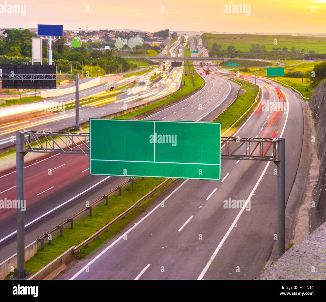 road with vehicles moving with blank sign sunset abstract Stock Photo ...