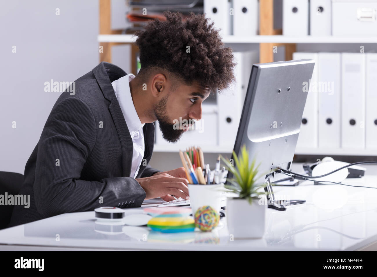 Side View Of A Young Businessman Working On Computer In Office Stock ...