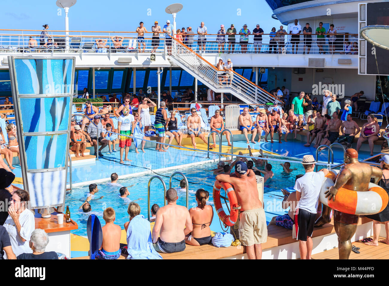 Passengers on the deck of a luxury cruise ship having fun around the ...