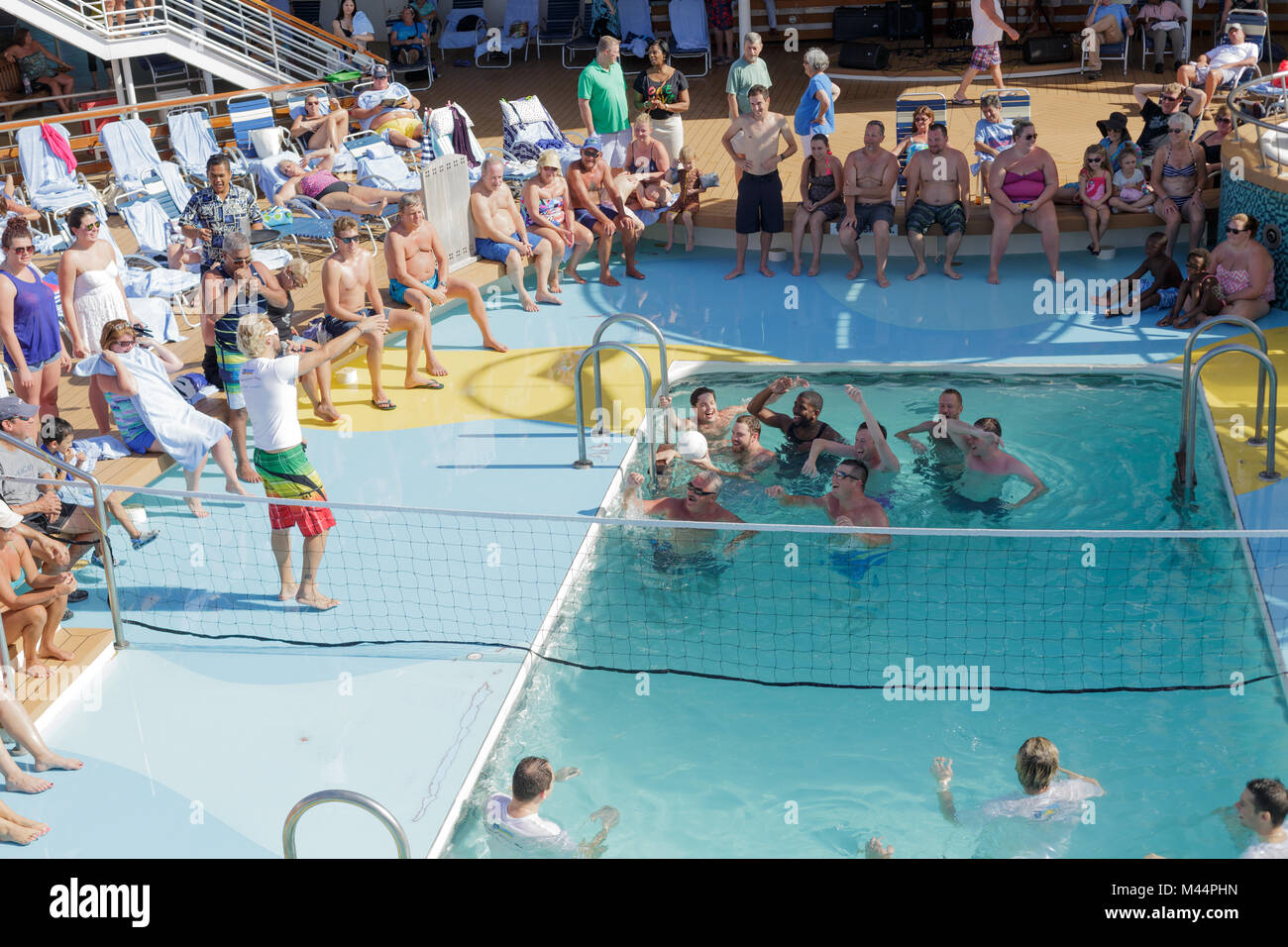 Passengers on the deck of a luxury cruise ship having fun around the ...