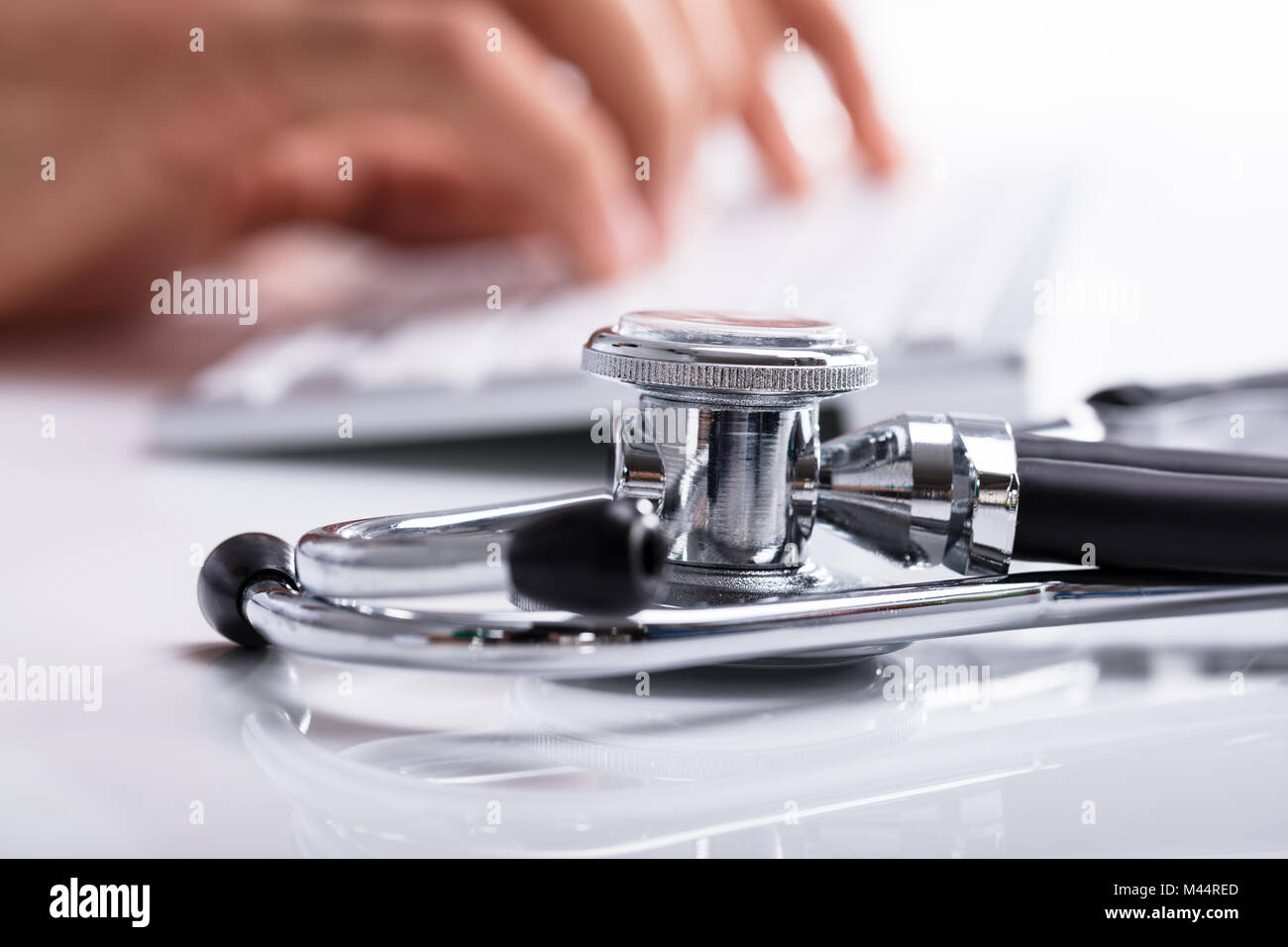 Doctor Typing On Computer Keyboard With Stethoscope On White Desk Stock ...