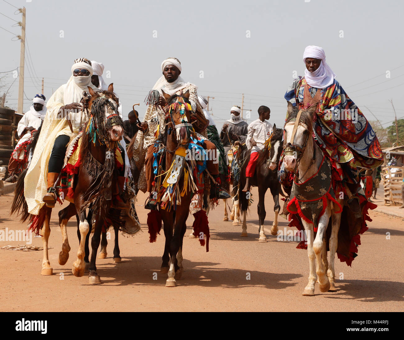 Peulh people on their horses Stock Photo - Alamy