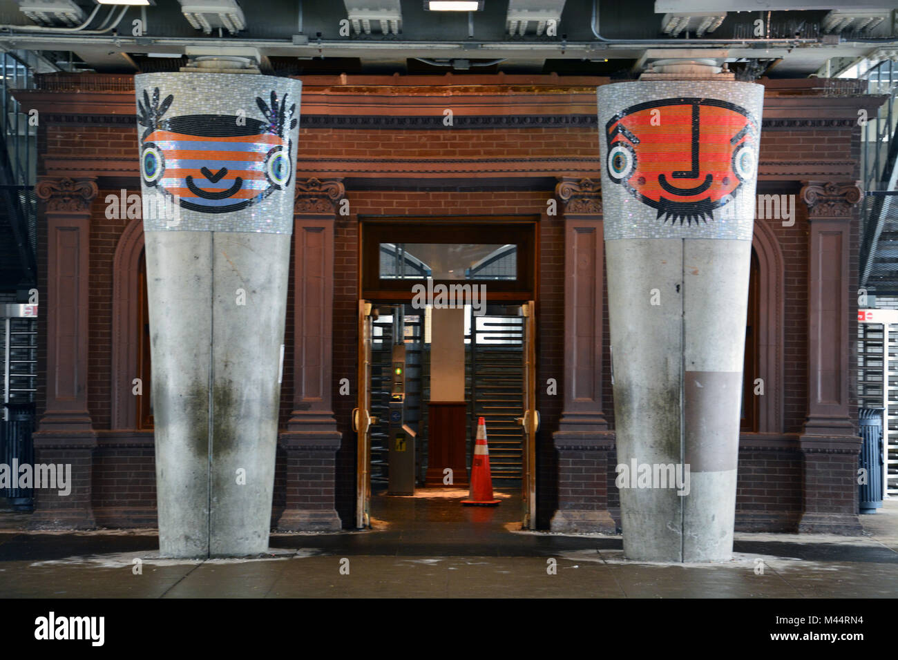 Two of nine tile mosaic faces by David Lee Csicsko in front of the ...