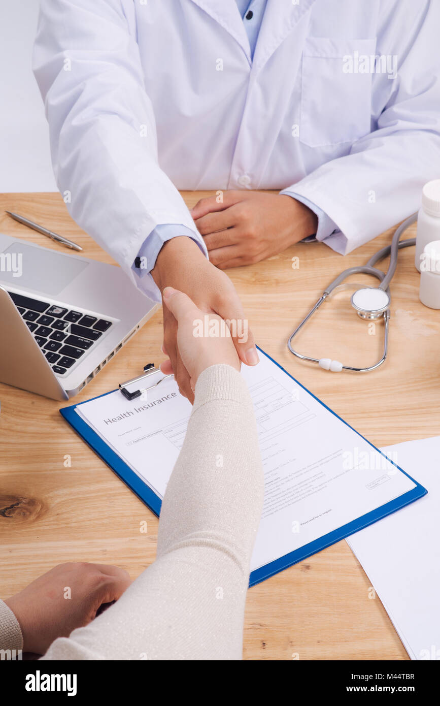 Hand of doctor reassuring her female patient Stock Photo - Alamy