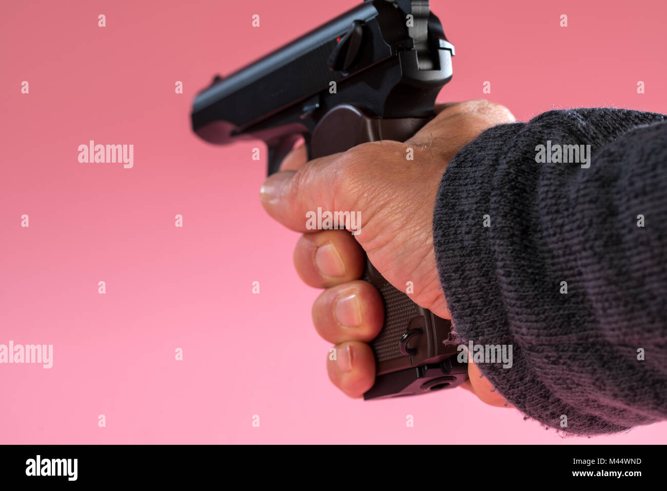 Male hand with gun Stock Photo - Alamy