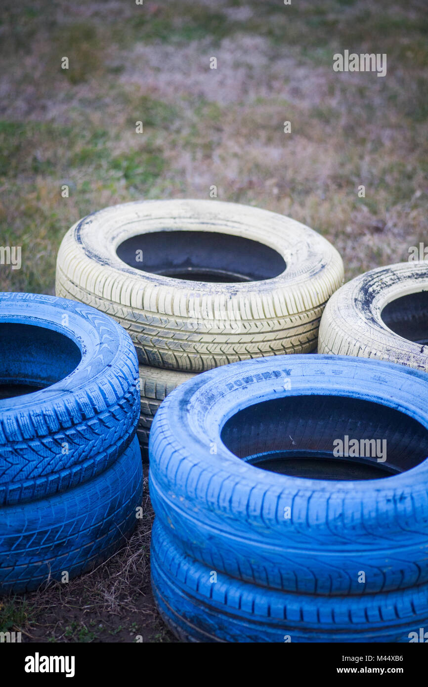 Yellow and blue tires on the floor of race course Stock Photo - Alamy