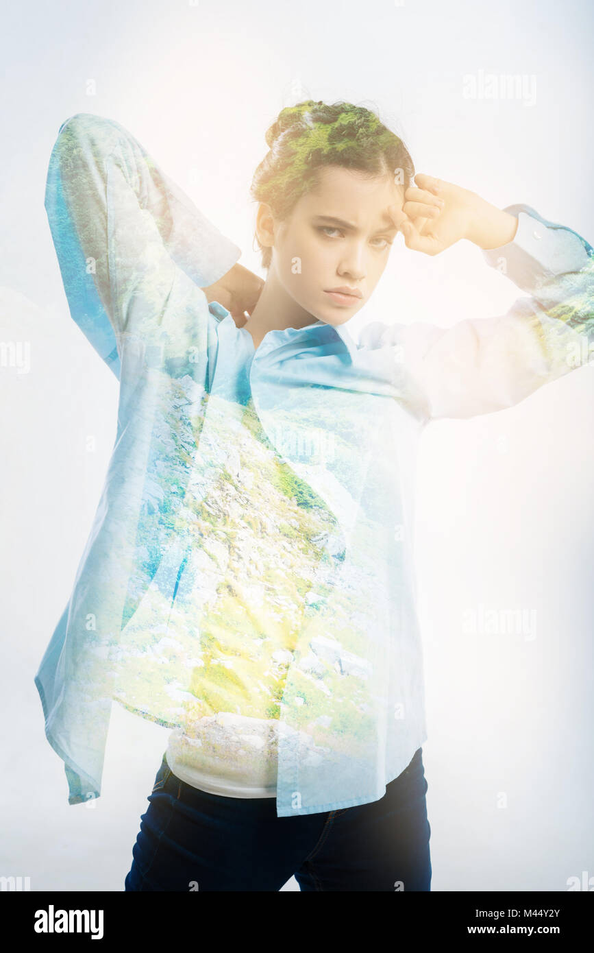 Fashion model frowning while posing for a photographer Stock Photo - Alamy