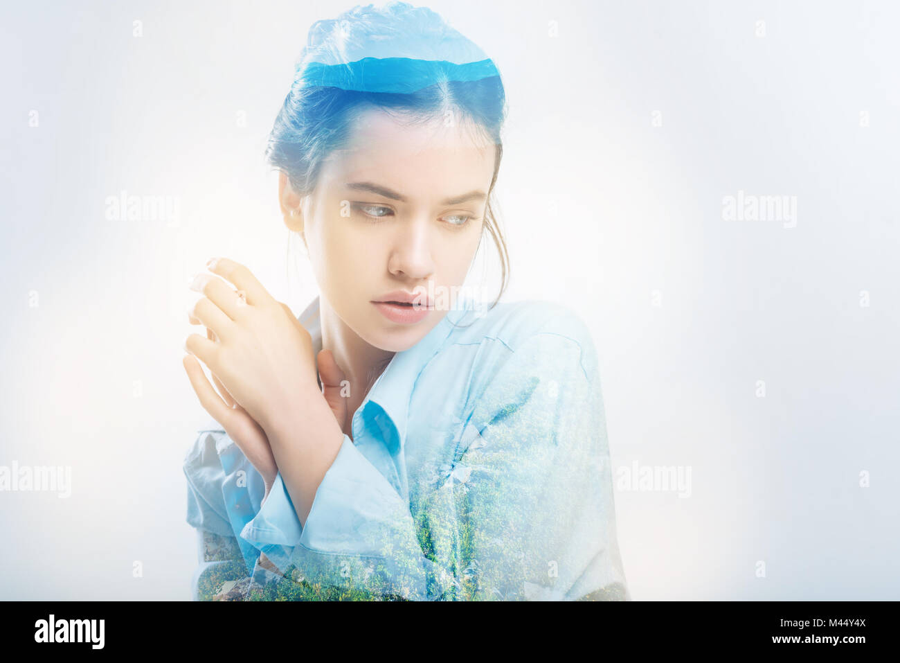 Emotional woman pressing her hands while being cold Stock Photo - Alamy