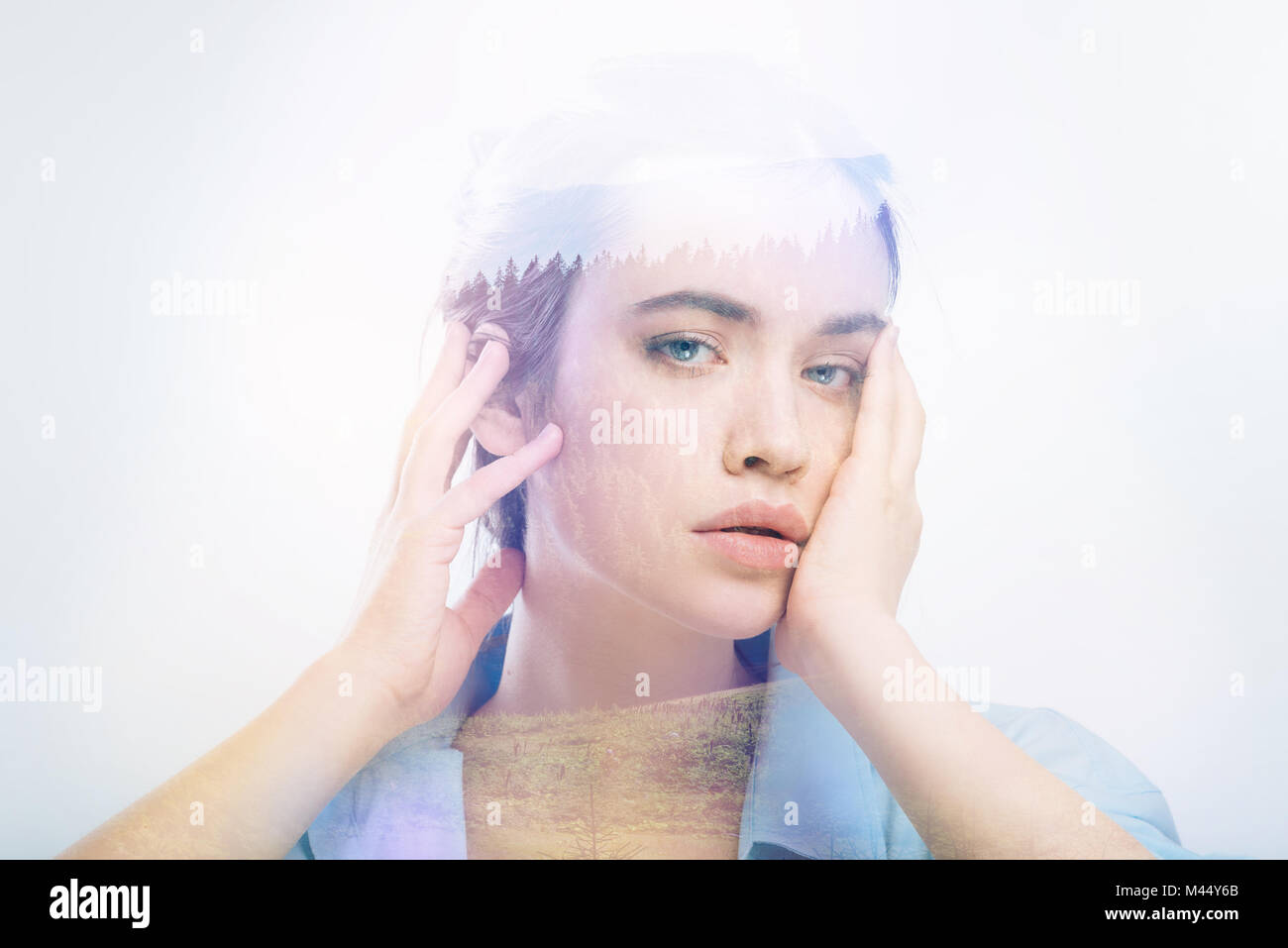 Exhausted employee touching her face after a difficult day Stock Photo ...