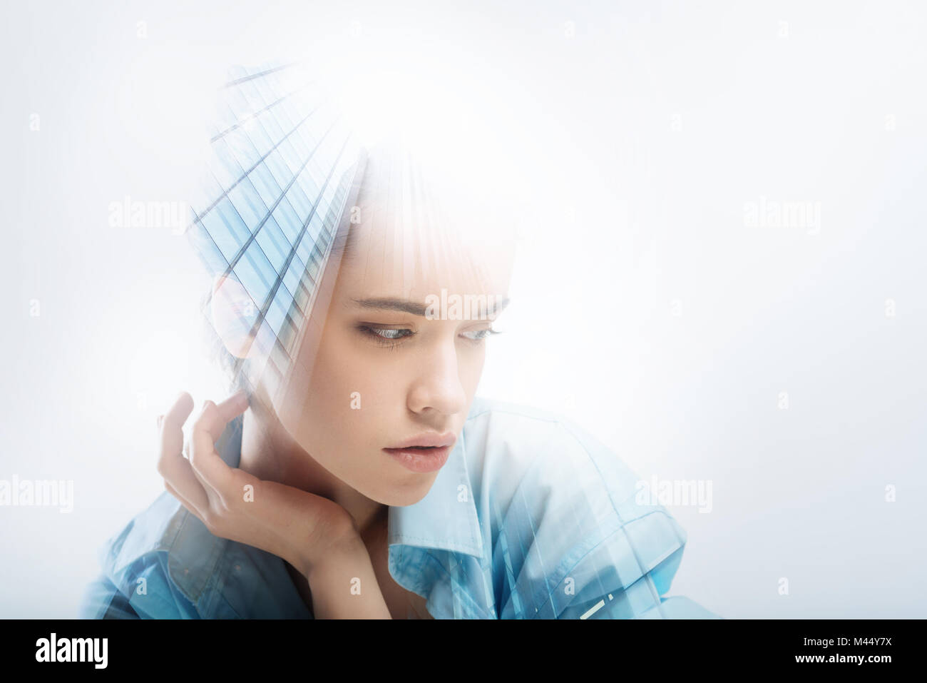 Pretty young person looking to the left and touching her neck Stock ...