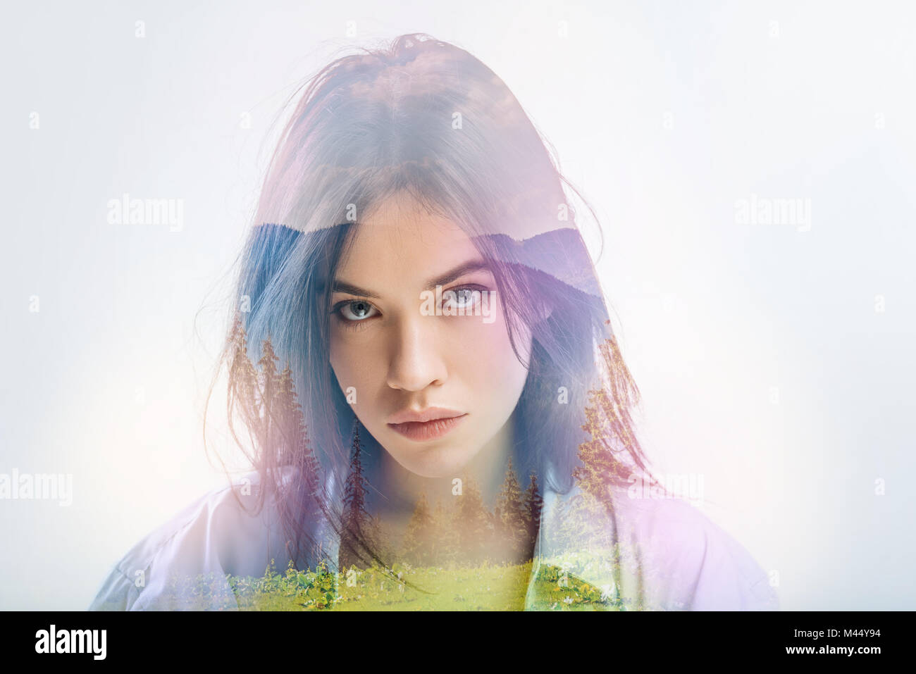 Pretty woman leaning her head and looking serious Stock Photo - Alamy