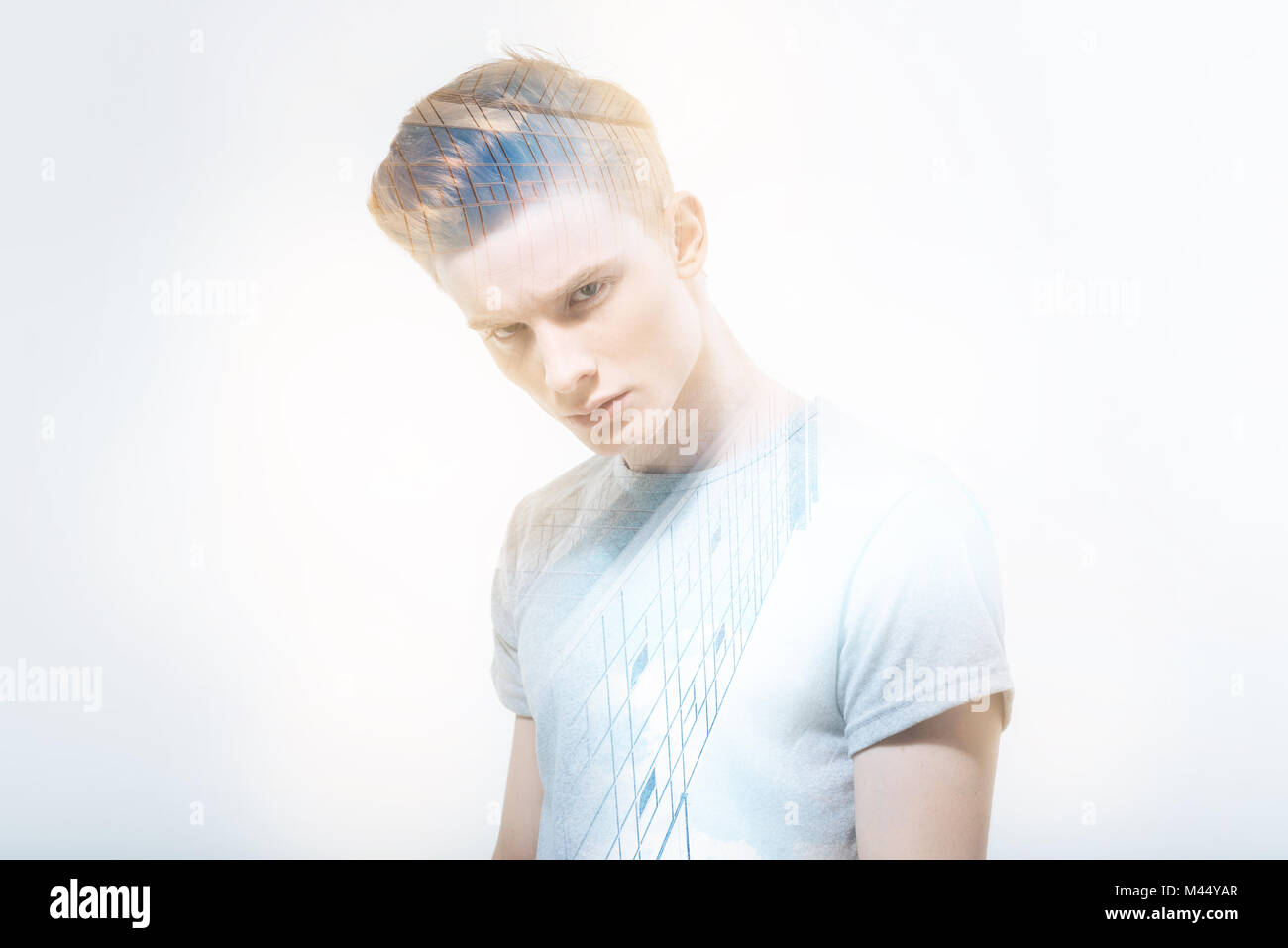 Young man frowning and seriously looking into the distance Stock Photo ...
