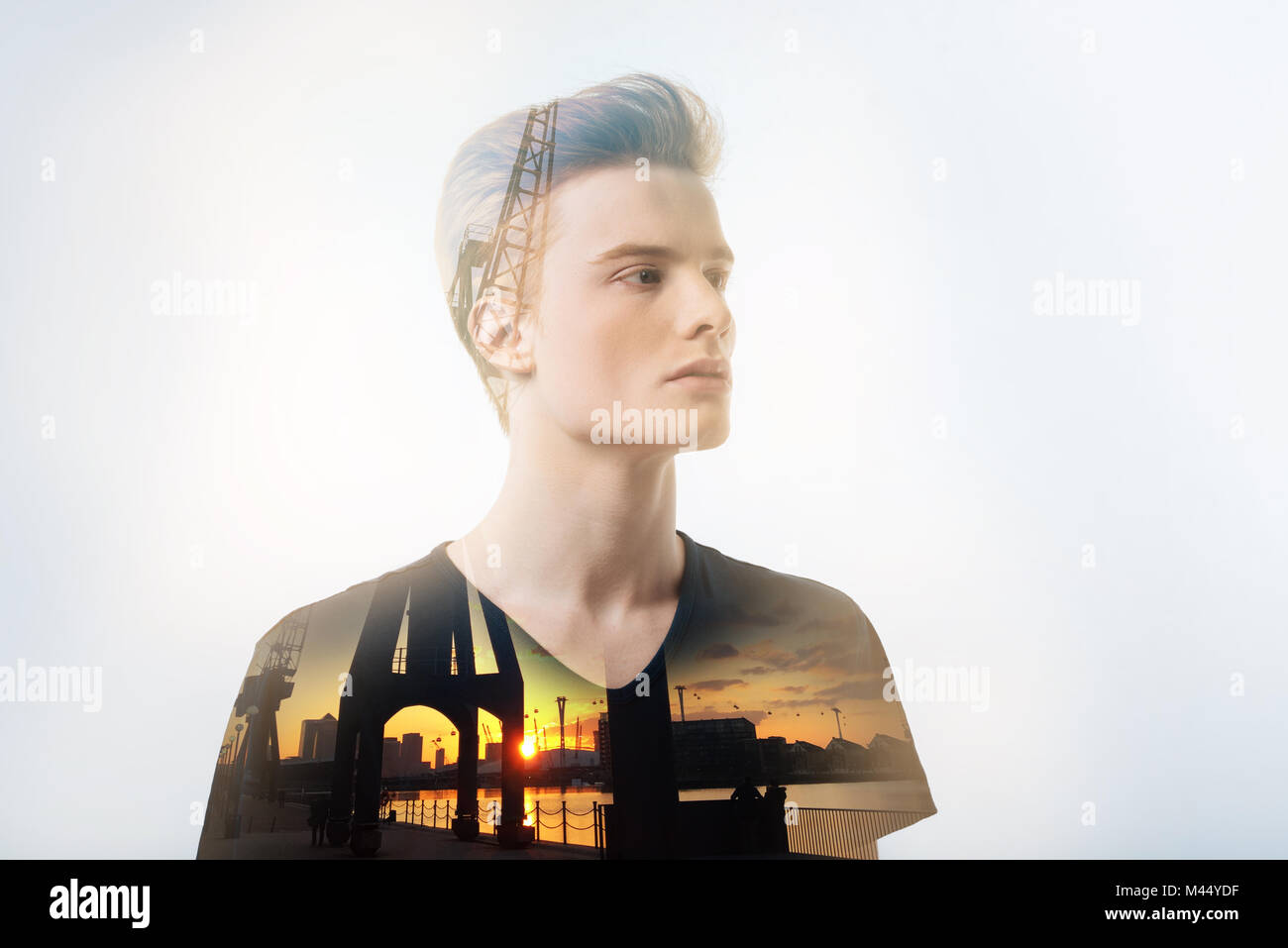 Attentive young man looking to the left and getting inspiration Stock ...