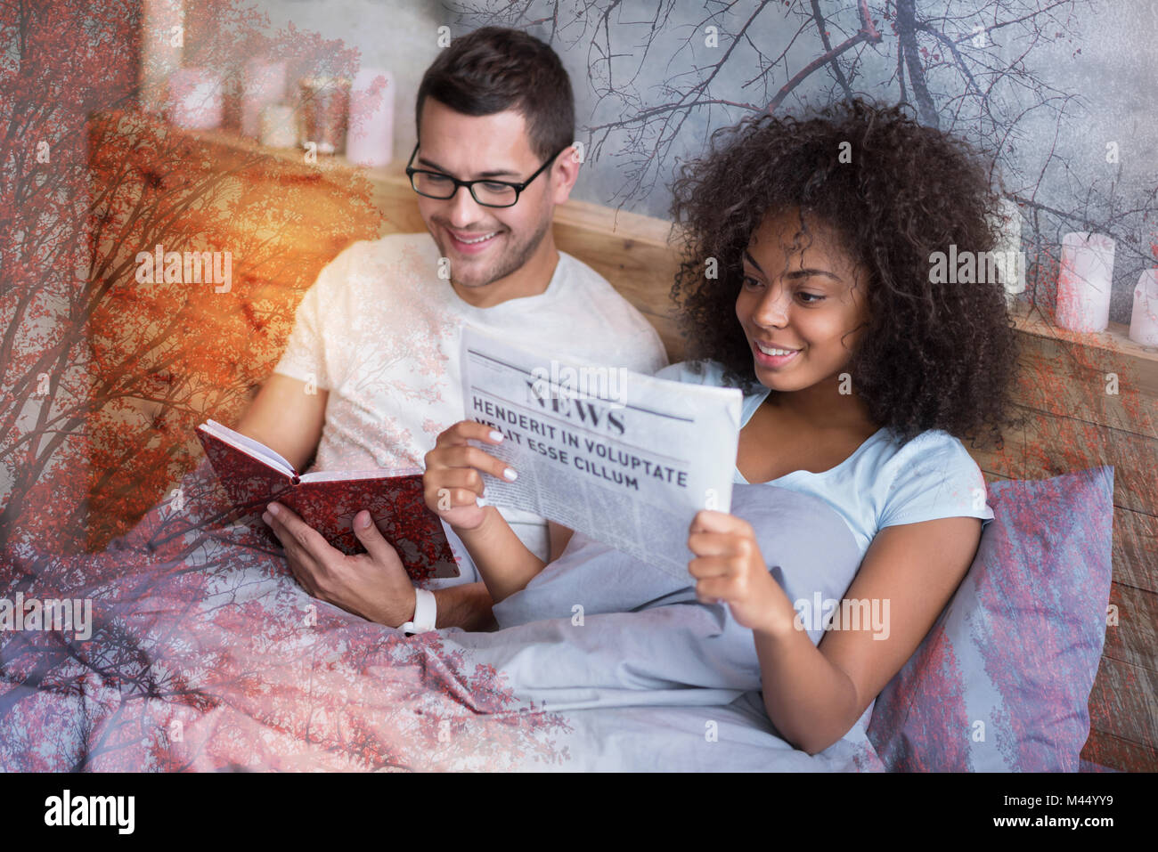 Delighted nice woman reading a newspaper Stock Photo - Alamy
