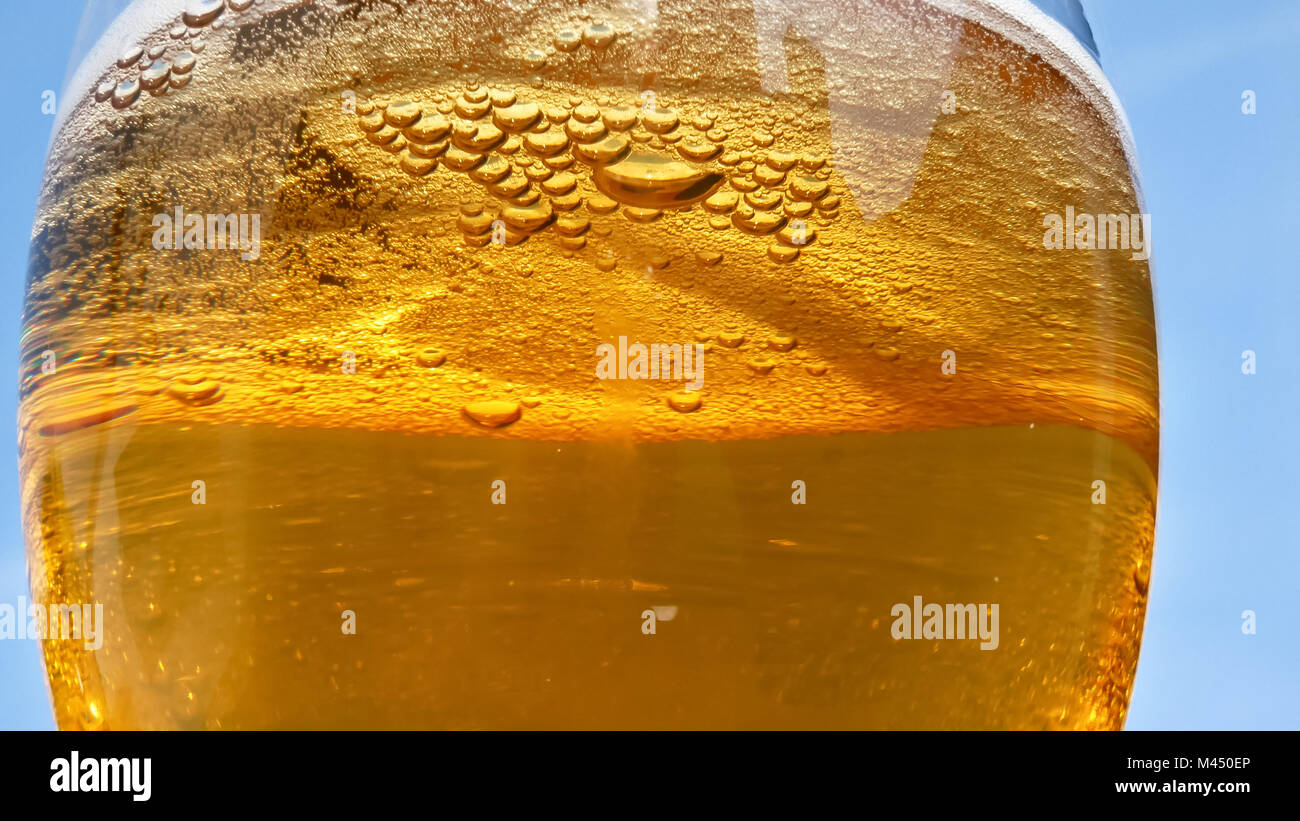 Detail of Beer Glass on the Blue Background. Bottom View Stock Photo ...