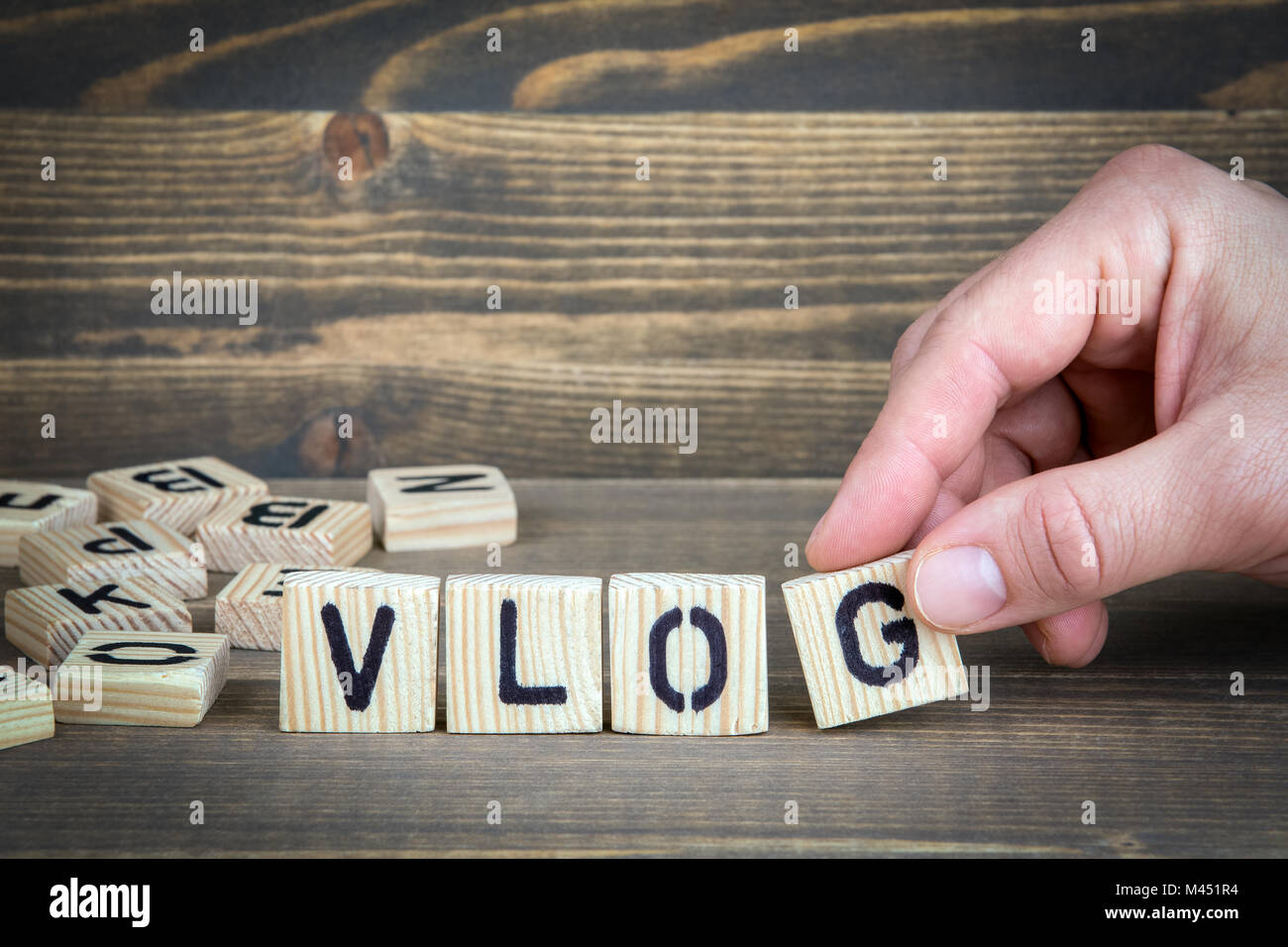 vlog. Wooden letters on the office desk, informative and communication ...