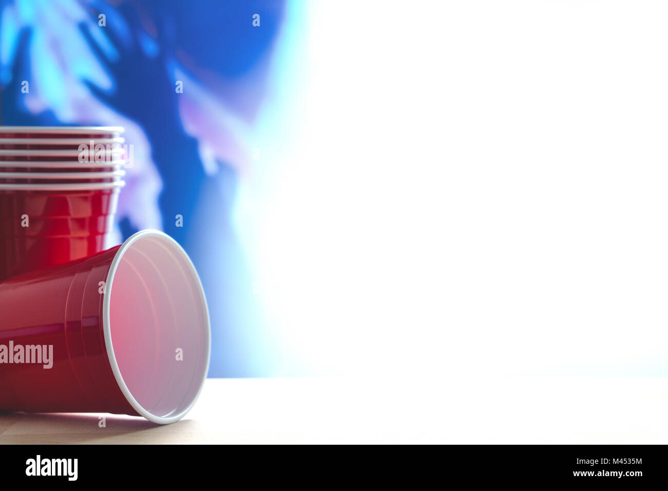 Red party cups themed background. People dancing hands up in the air in ...