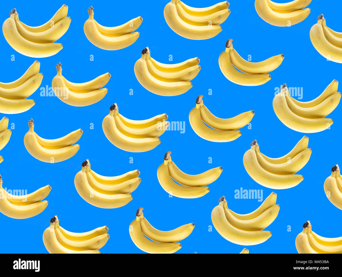 Bananas on the blue background Stock Photo - Alamy