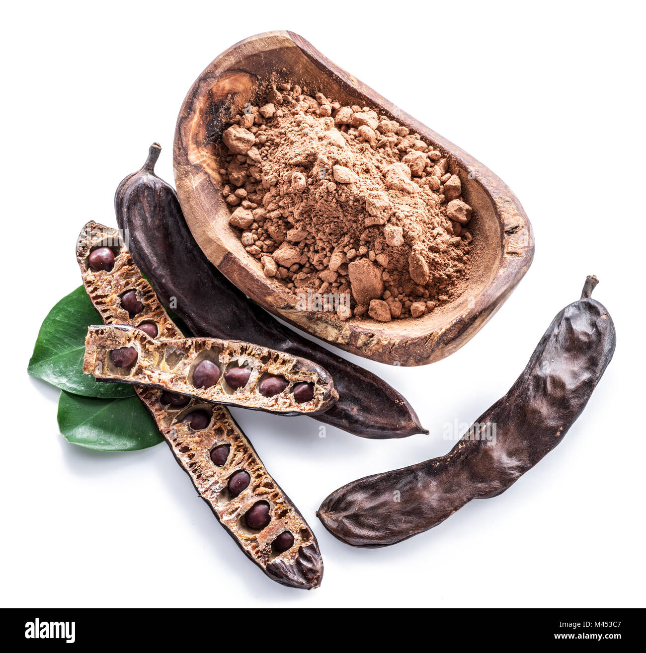 Carob pods and carob powder in the wooden bowl. White background Stock ...