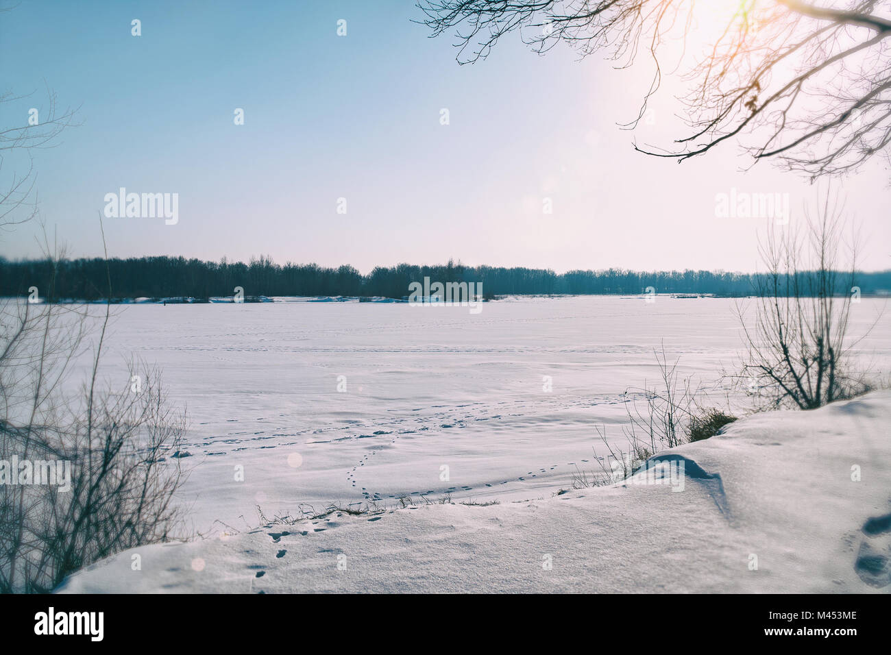 Winter landscape. Snow-covered lake in the distance is the beautiful ...