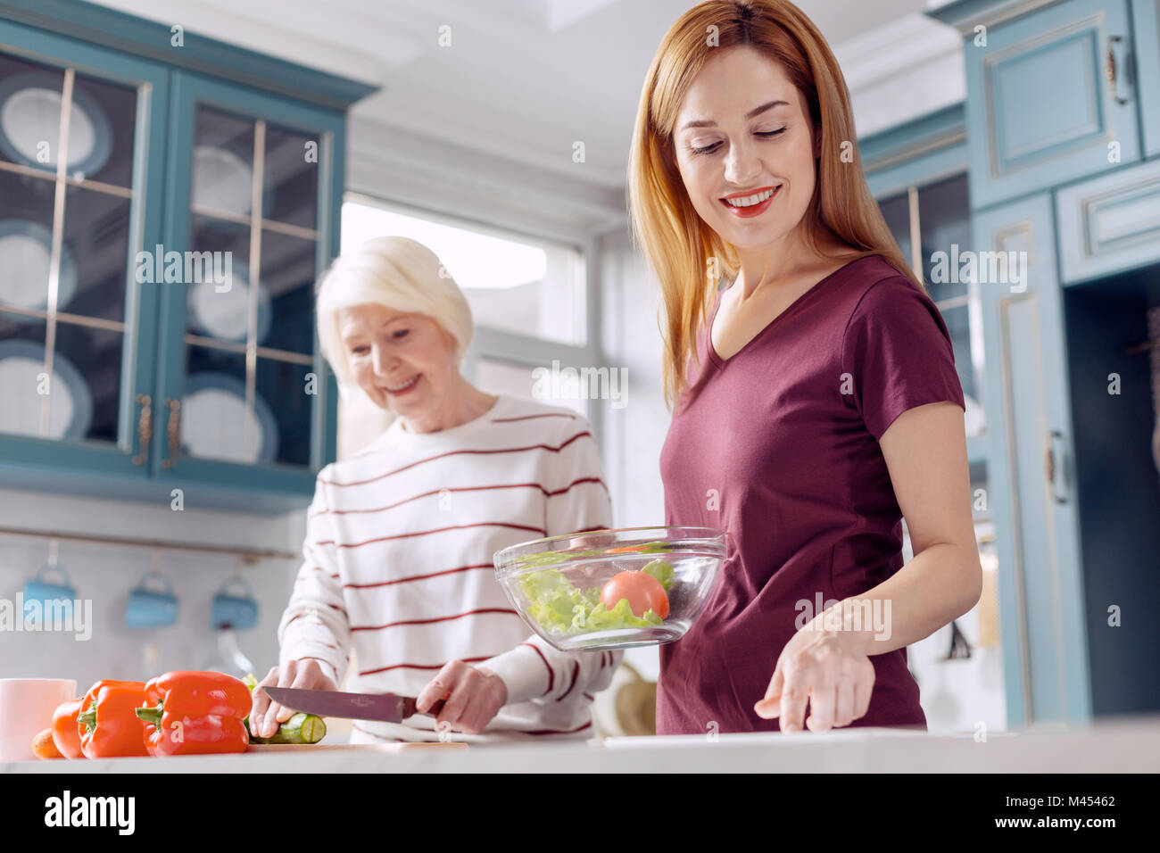 Mature woman making salad hi-res stock photography and images - Alamy