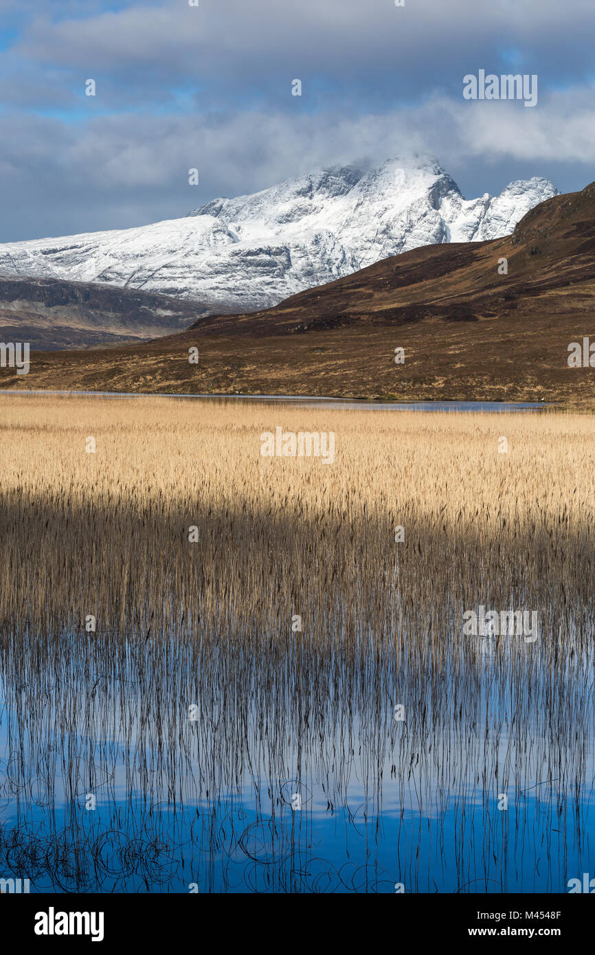 A snow-capped Blabheinn (Blaven) seen from the bank of Loch Cill ...