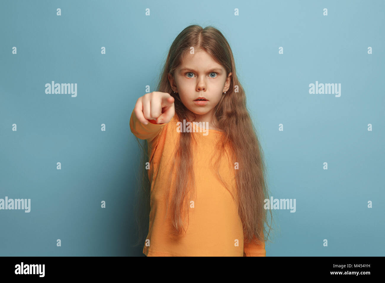 The determination. Teen girl on a blue background. Facial expressions ...